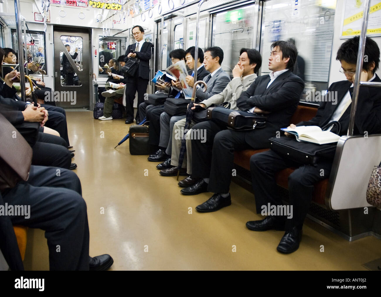 Stock photo of Japanese businessmen riding the Tokyo subway Stock Photo ...