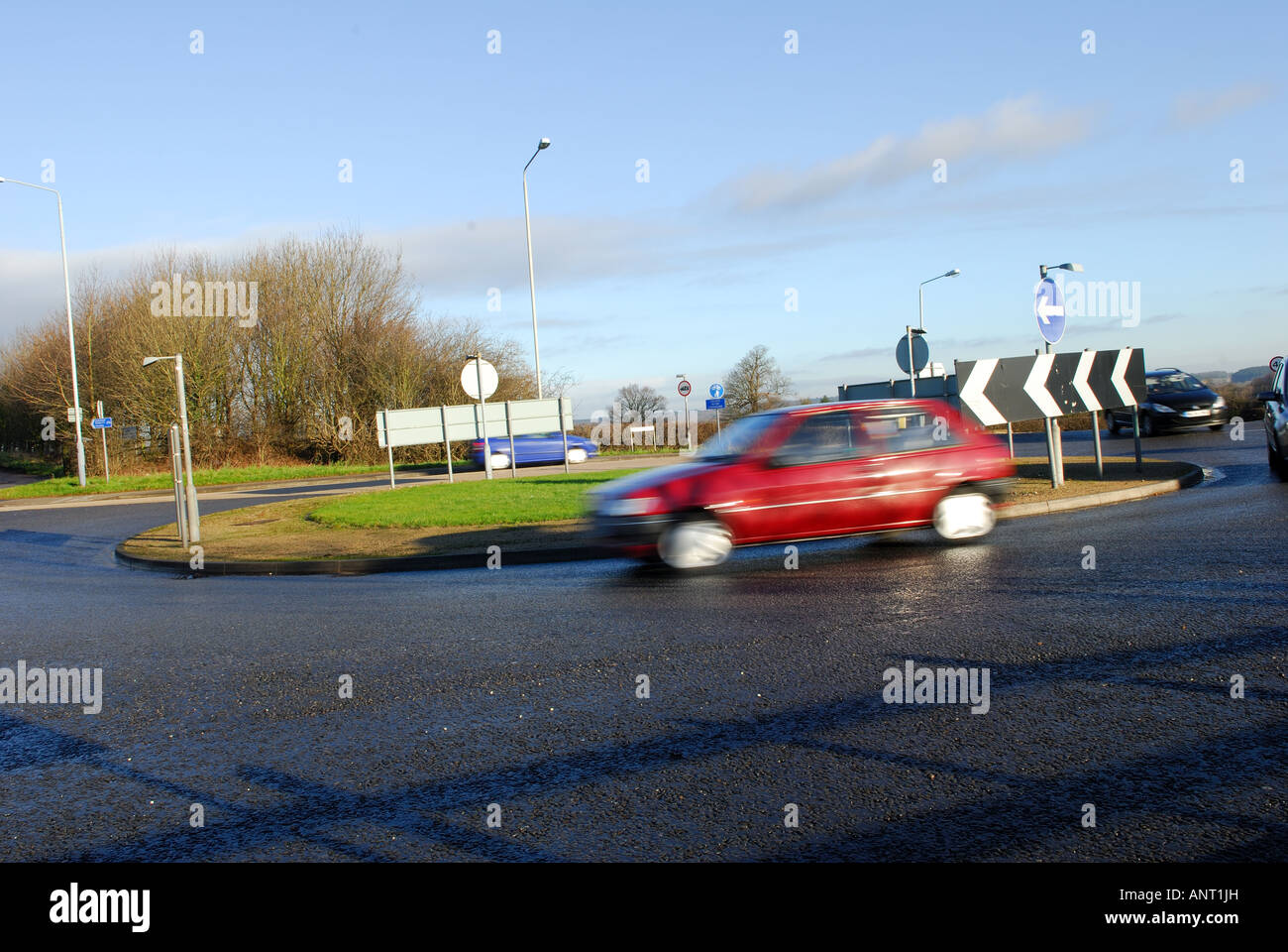 Red car at roundabout Stock Photo - Alamy