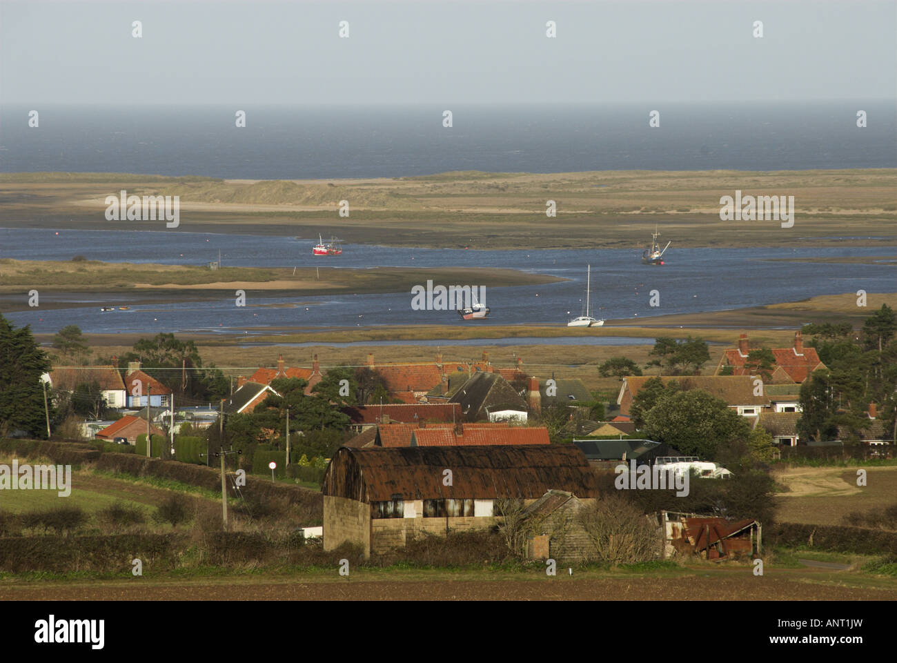 View of Brancaster showing Village harbour channel and Scolt head ...
