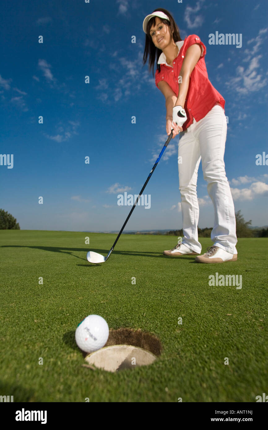 young woman playing golf Stock Photo - Alamy