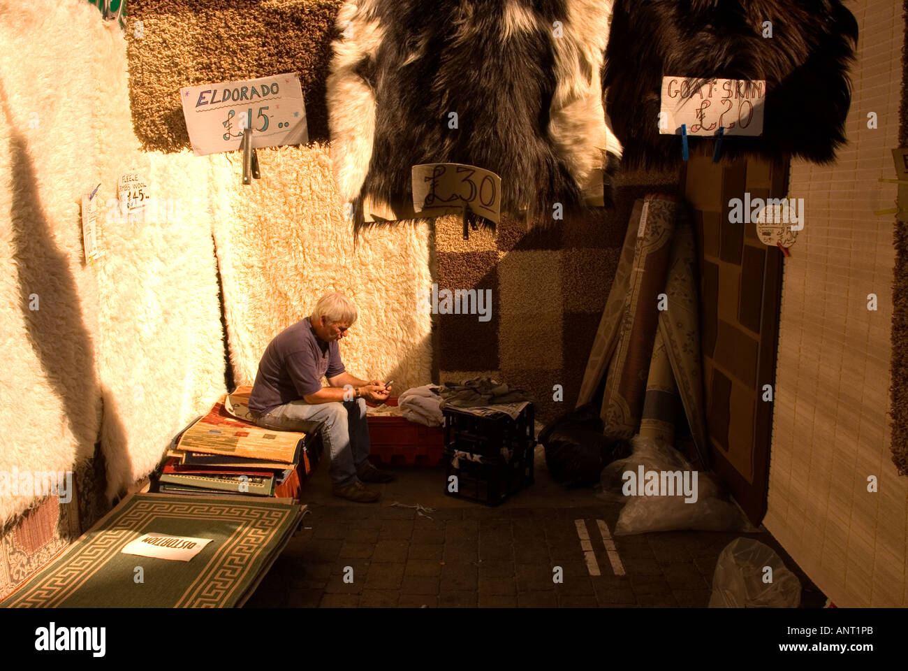 Brick Lane Festival London UK. Carpet and rug stall vendor with his ...