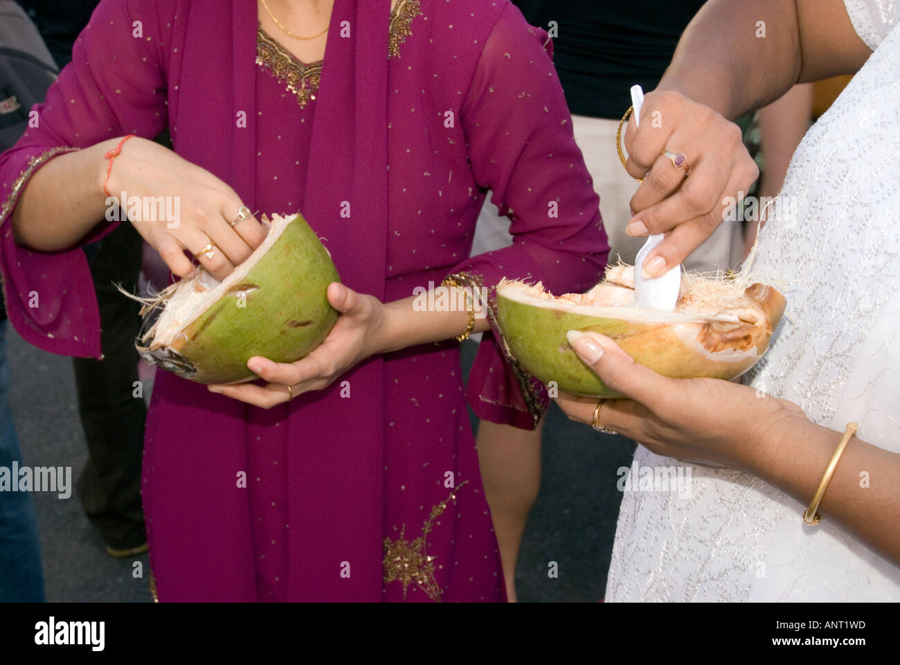 Visitors eating coconuts at Brick Lane Festival, London, UK Stock Photo ...