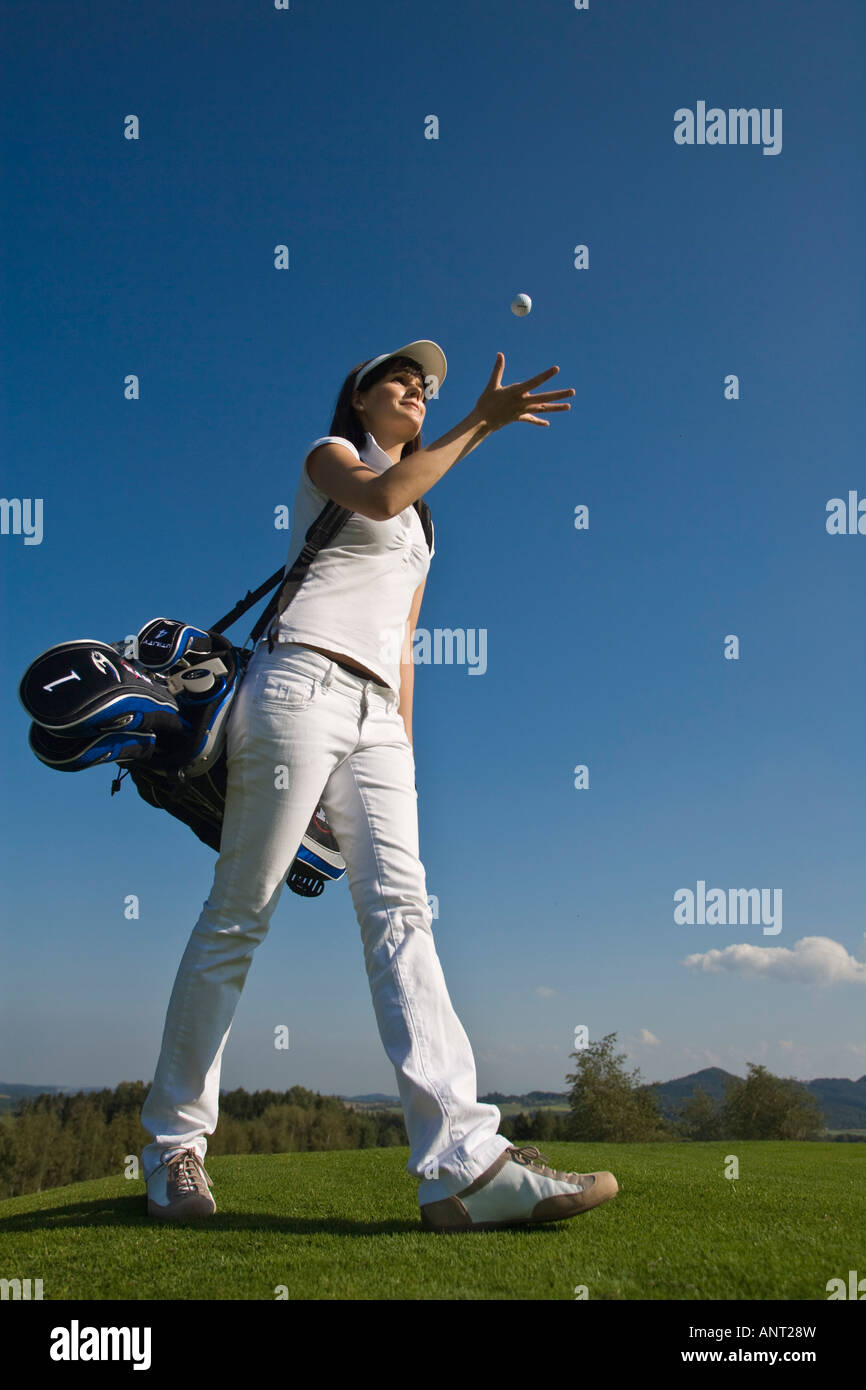 young woman playing golf Stock Photo - Alamy