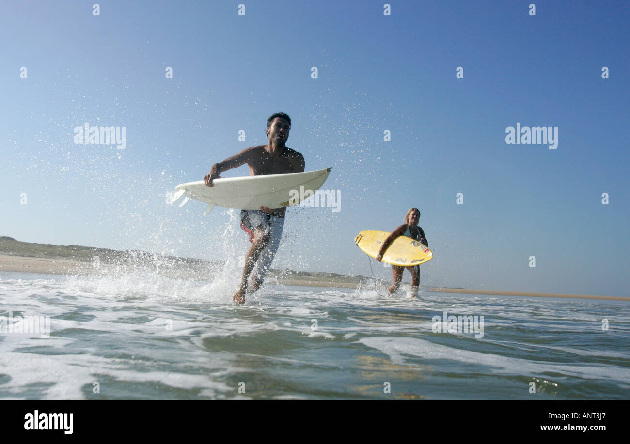 Running carrying surf board surfboard hi-res stock photography and ...