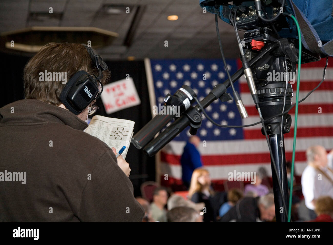 Cameraman does crossword puzzle while waiting for political rally to ...