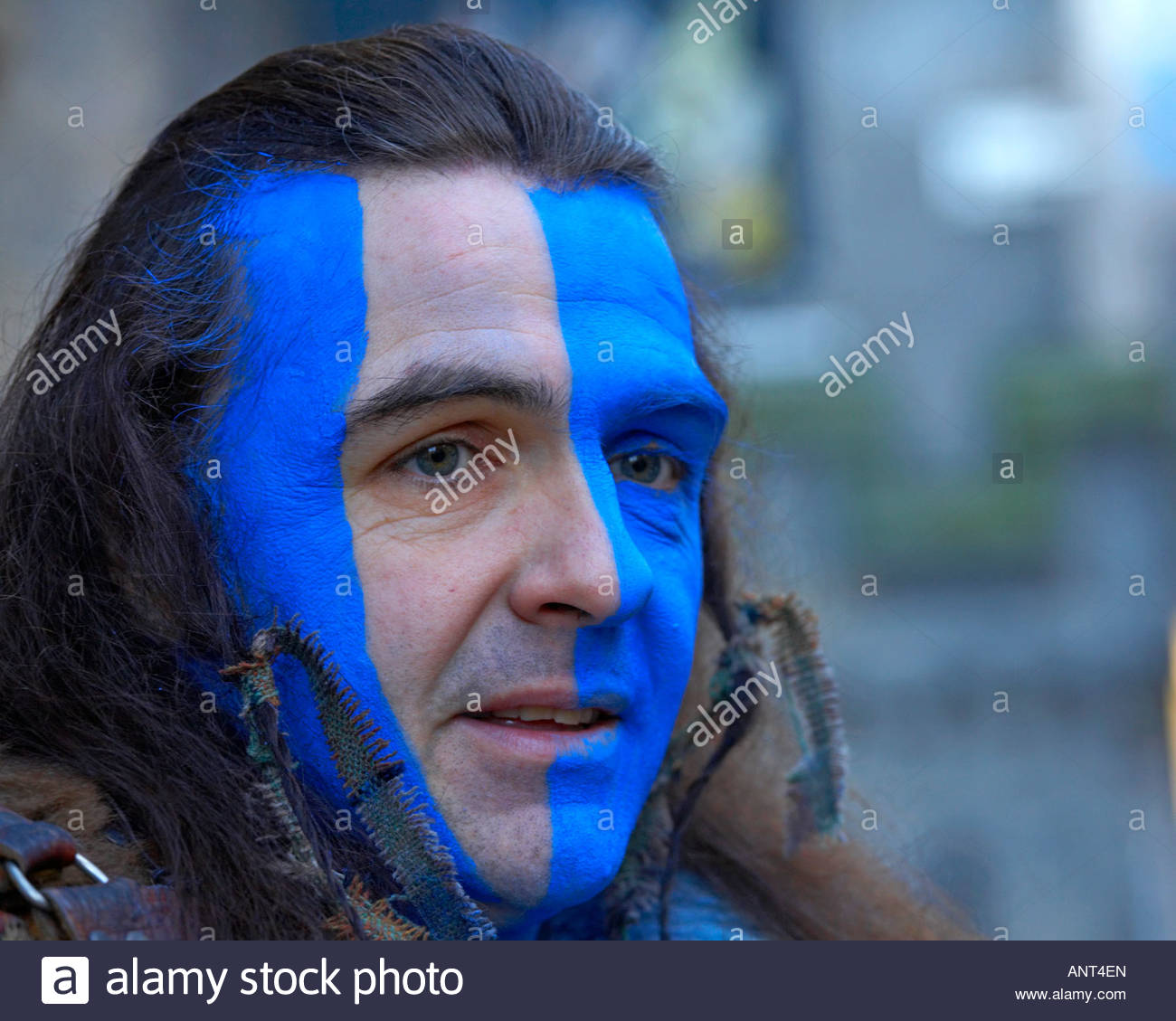 A Charity performer with the Scottish flag facepaint and dressed in a ...