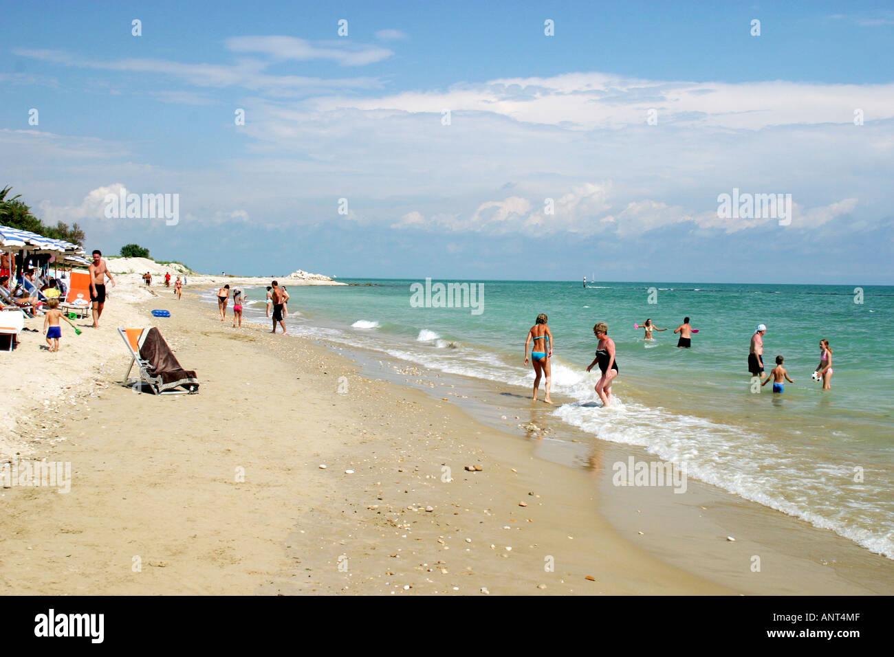 Holiday makers relaxing on the beach of the Adriatic coast of Le Marche ...