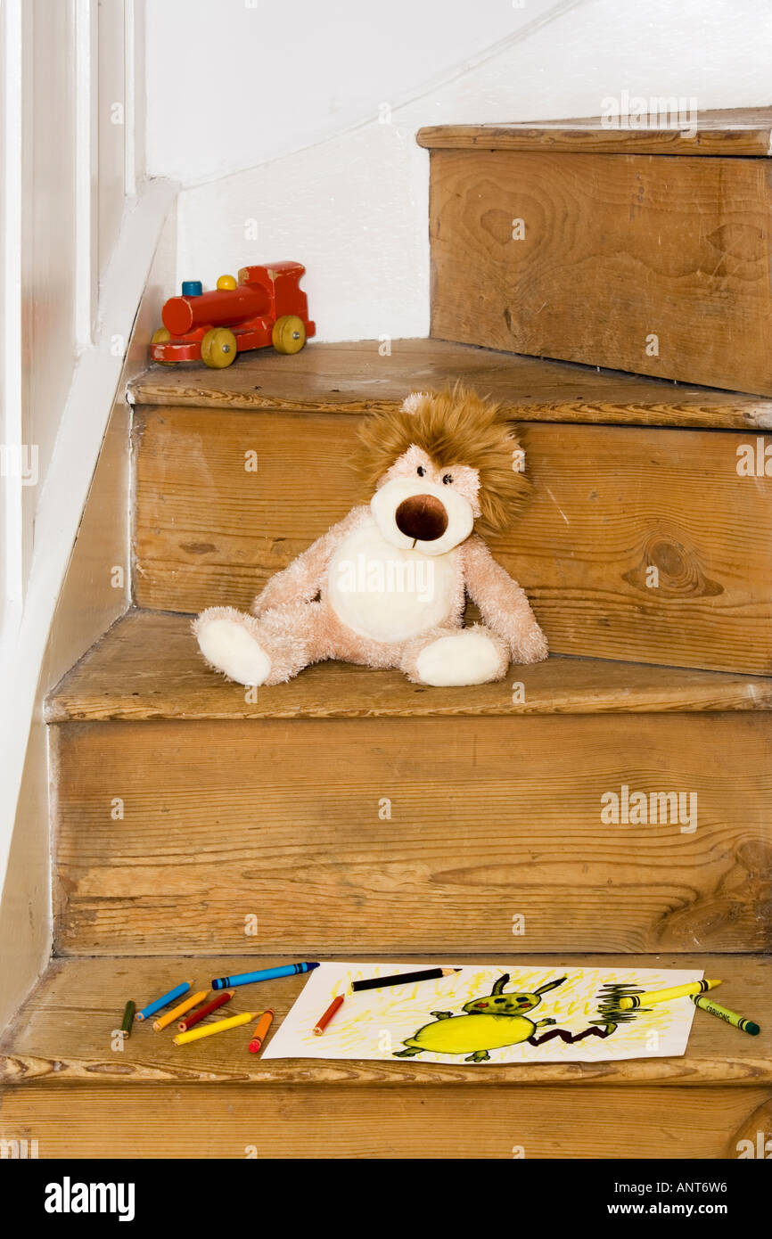 Child's drawing, cuddly toy and wooden train on stairs Stock Photo - Alamy