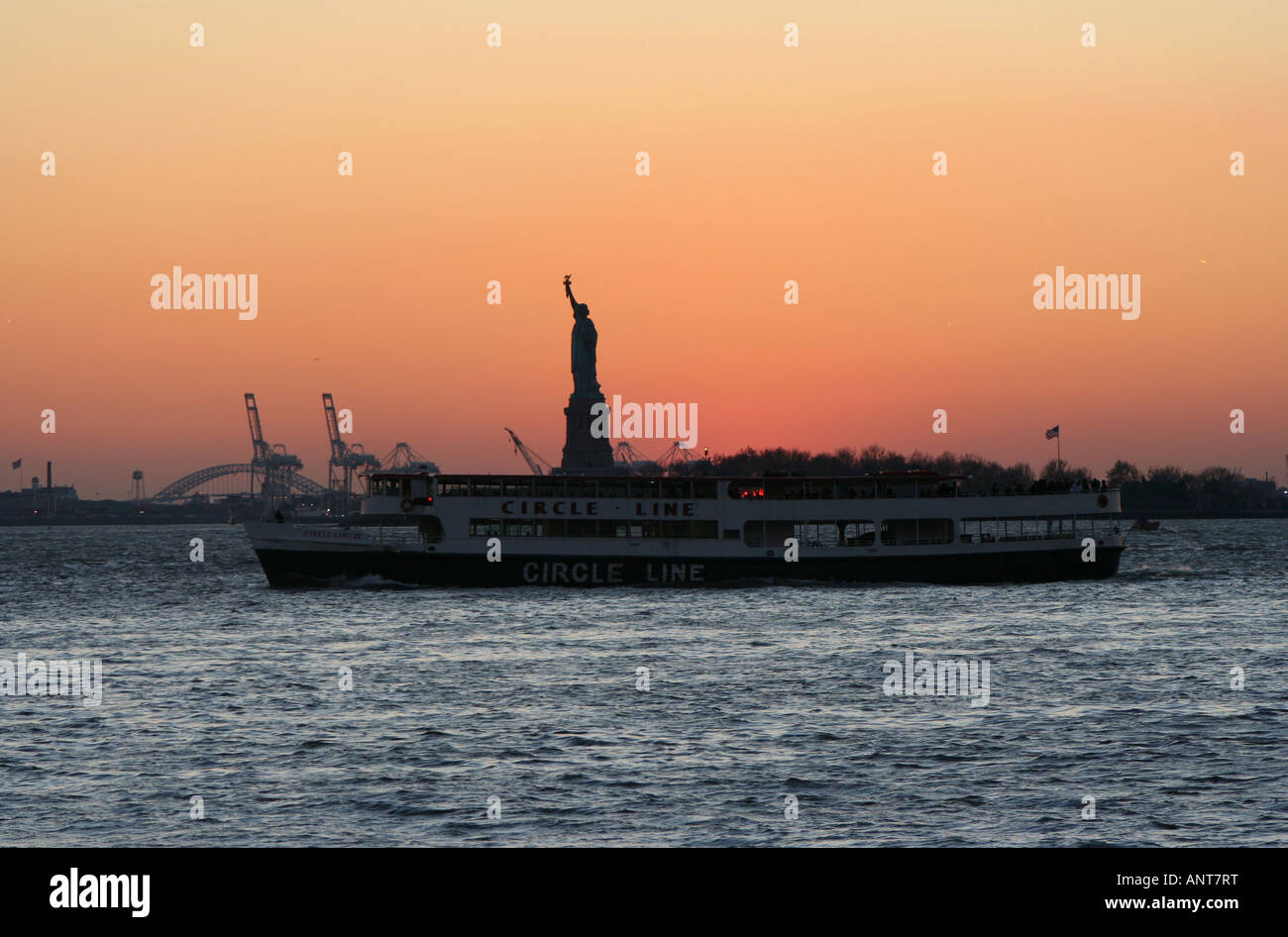 Circle line ferry and Statue of Liberty at sunset New York City ...