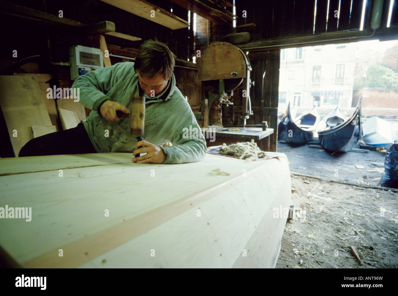 Italy Venice Craftsman at work building a gondola at the squero in San ...