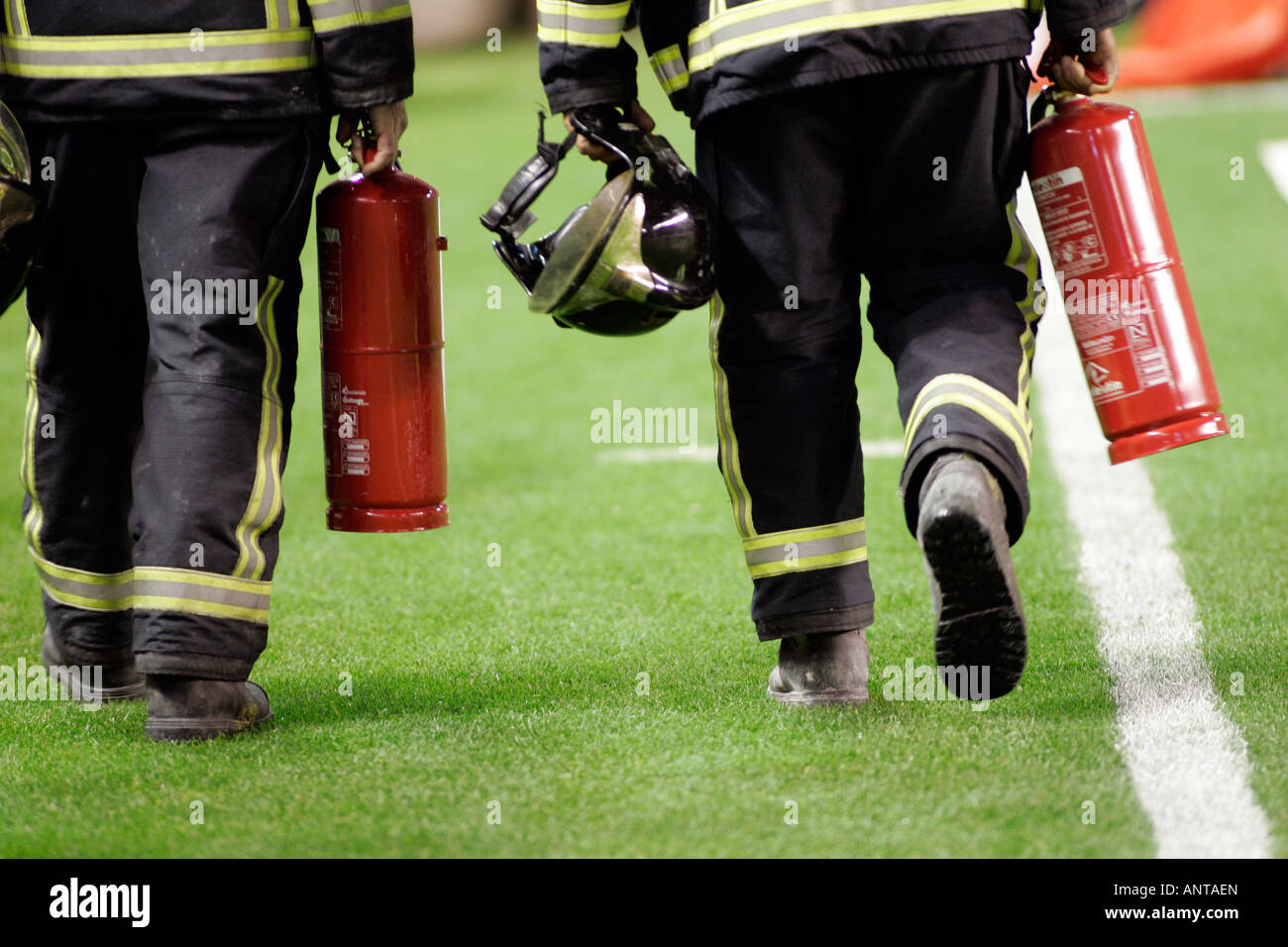 Firefighters on a football stadium Stock Photo - Alamy