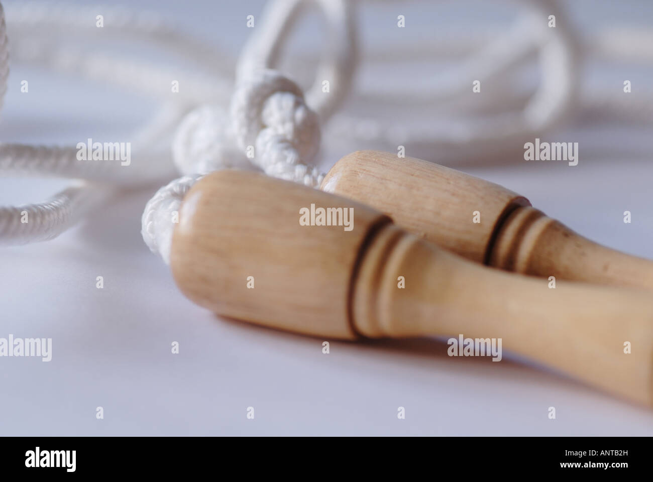 A clean still life image of a skipping rope with wooden handles Stock ...