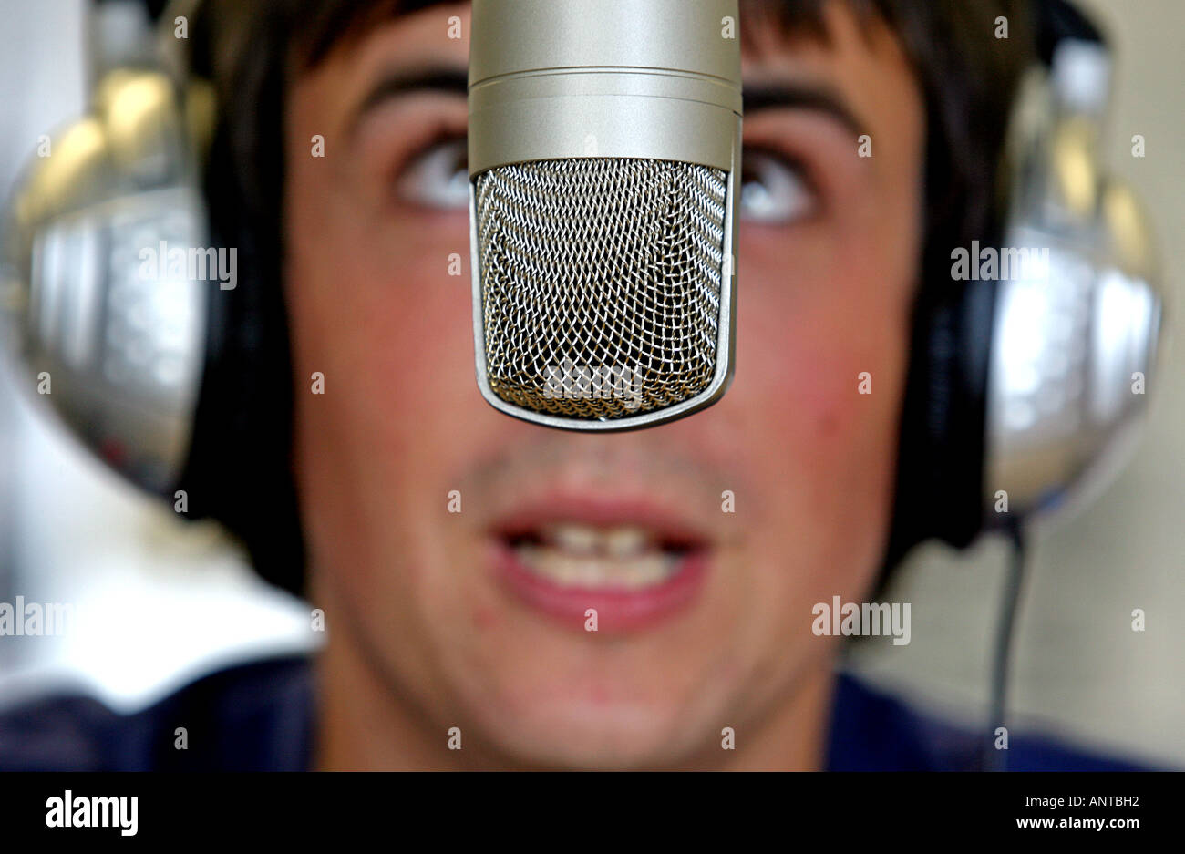 Boy using microphone in a studio Stock Photo - Alamy