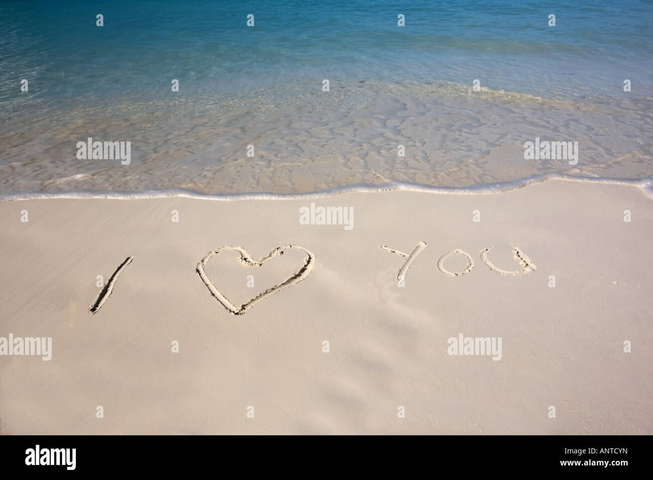 Valentine message written in the sand on a tropical beach Stock Photo ...