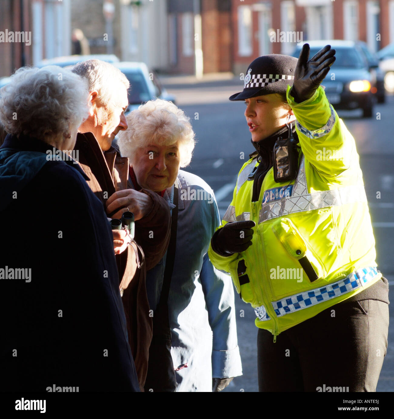 Female Police Officer Giving Directions to an Elderly Group of People ... Female Police Officer Giving Directions to an Elderly Group of People ...