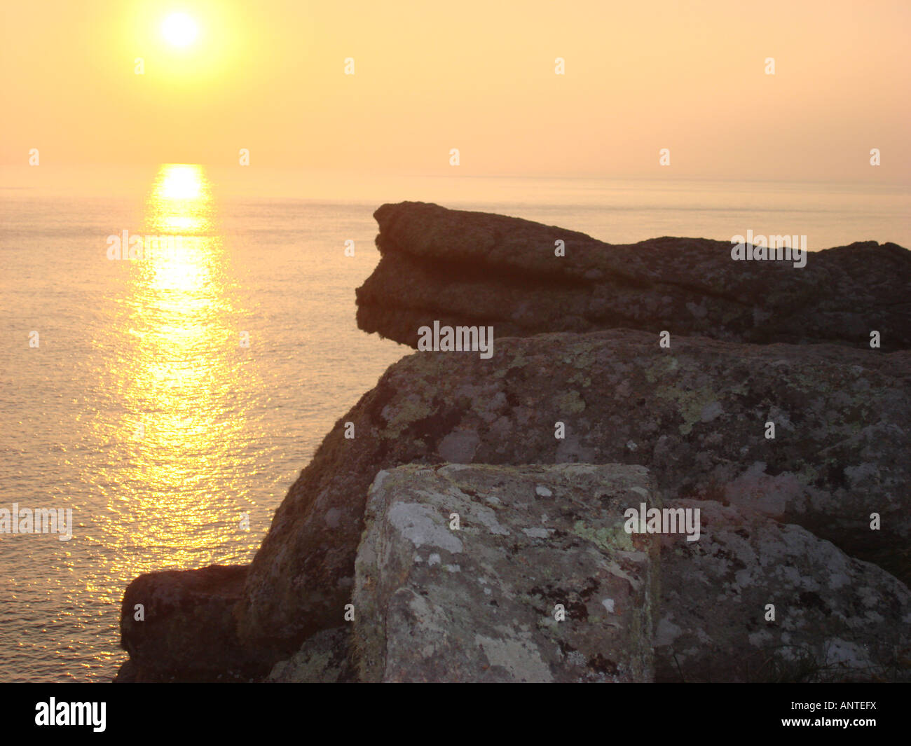 Sunset behind the rocks Stock Photo - Alamy