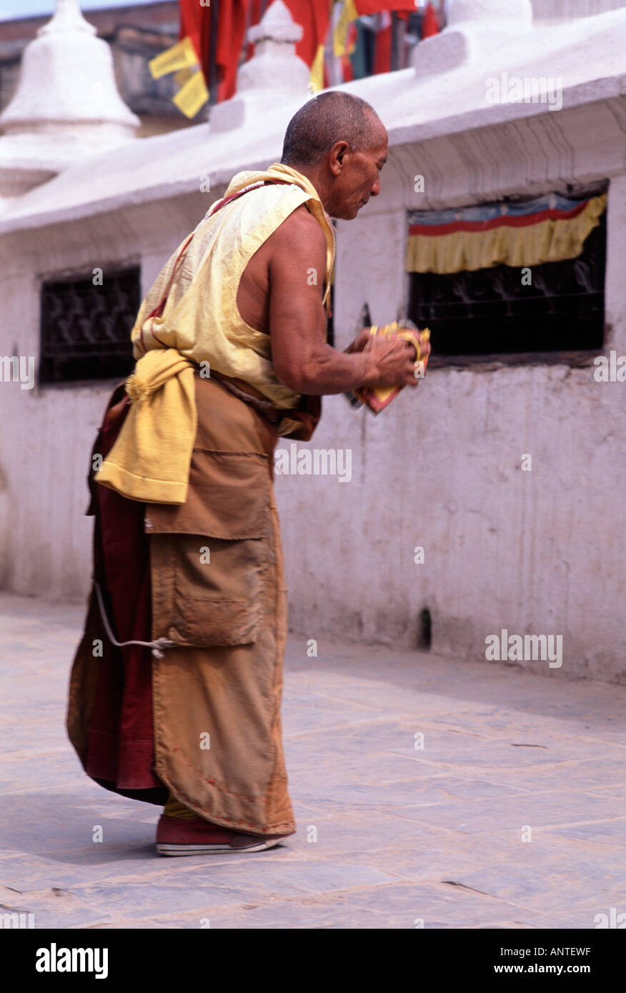 Tibetan Buddhist monk praying at the great stupa in Boudhnanth, Nepal ...