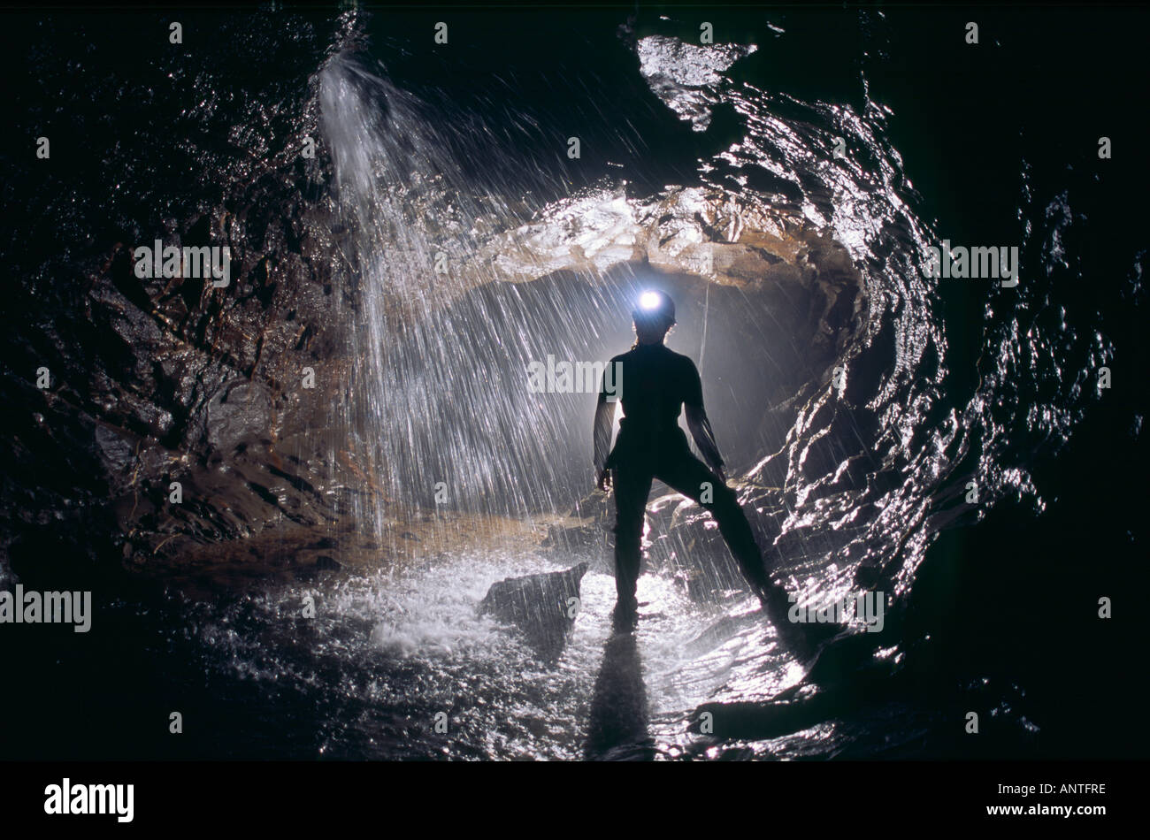 A female caver with a waterfall Dan yr Ogof Brecon Beacons South Wales ...