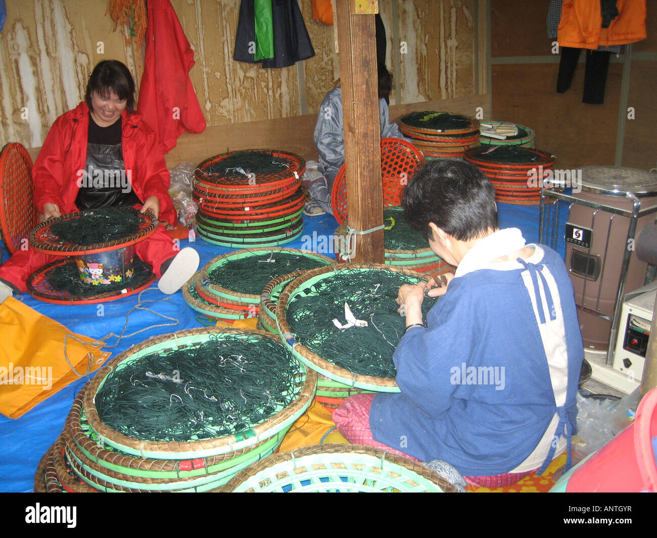 Women mending fishing nets Kushiro Hokkaido Japan Stock Photo - Alamy