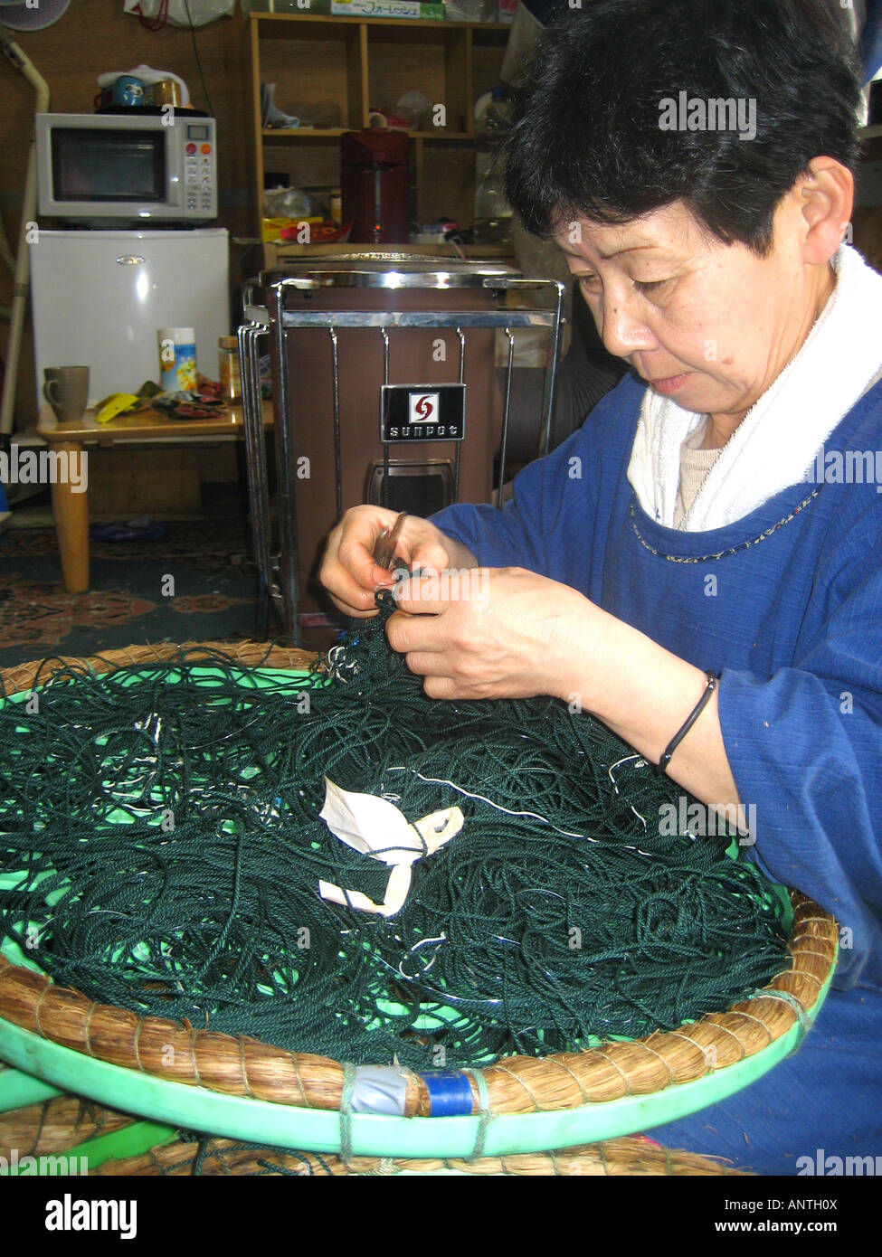 Woman Mending Fishing Nets High Resolution Stock Photography and Images ...