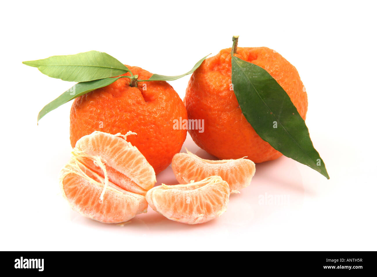 two mandarins with leaf and slices isolated on white background fruits ...