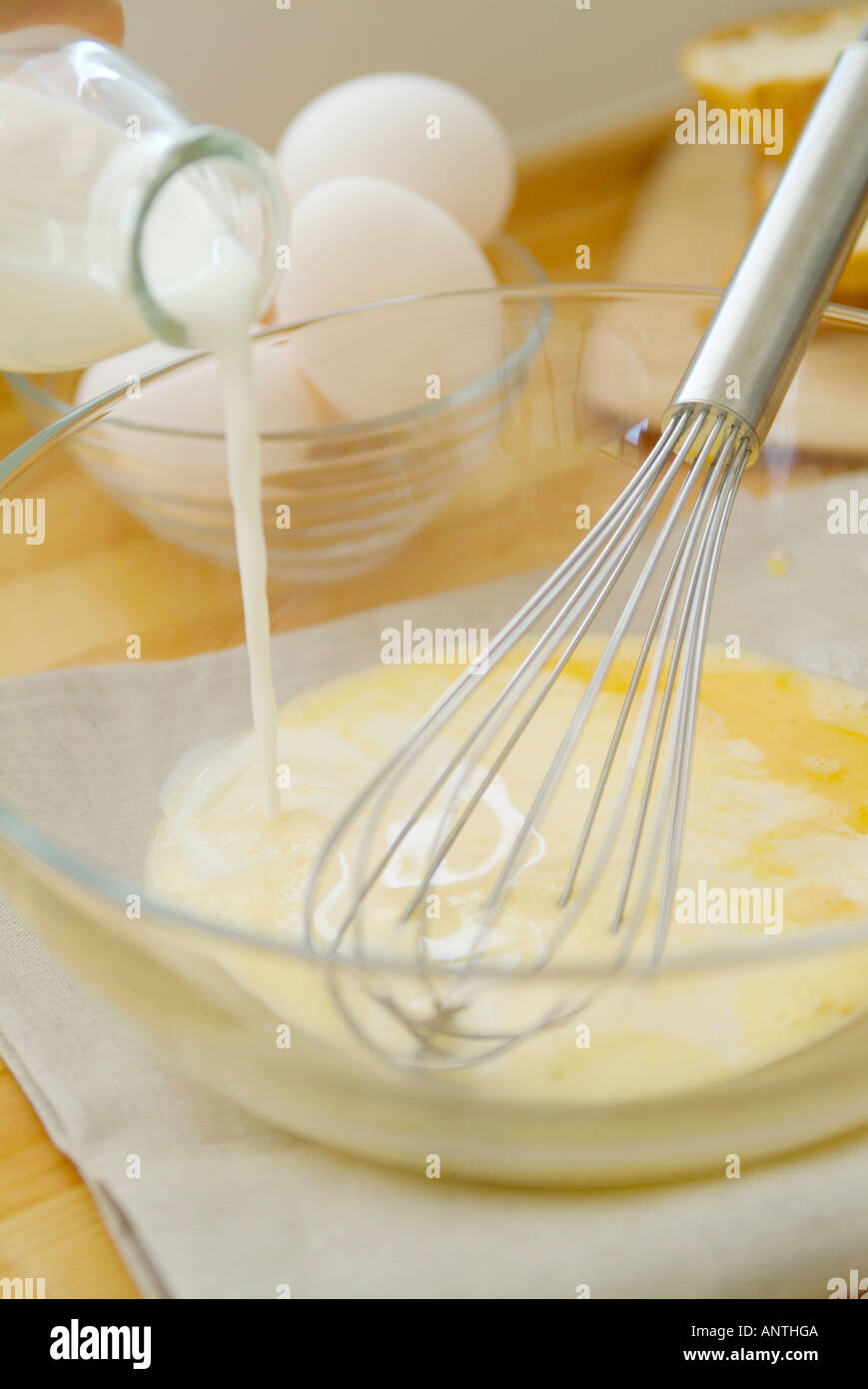 Pouring milk into bowl Stock Photo - Alamy