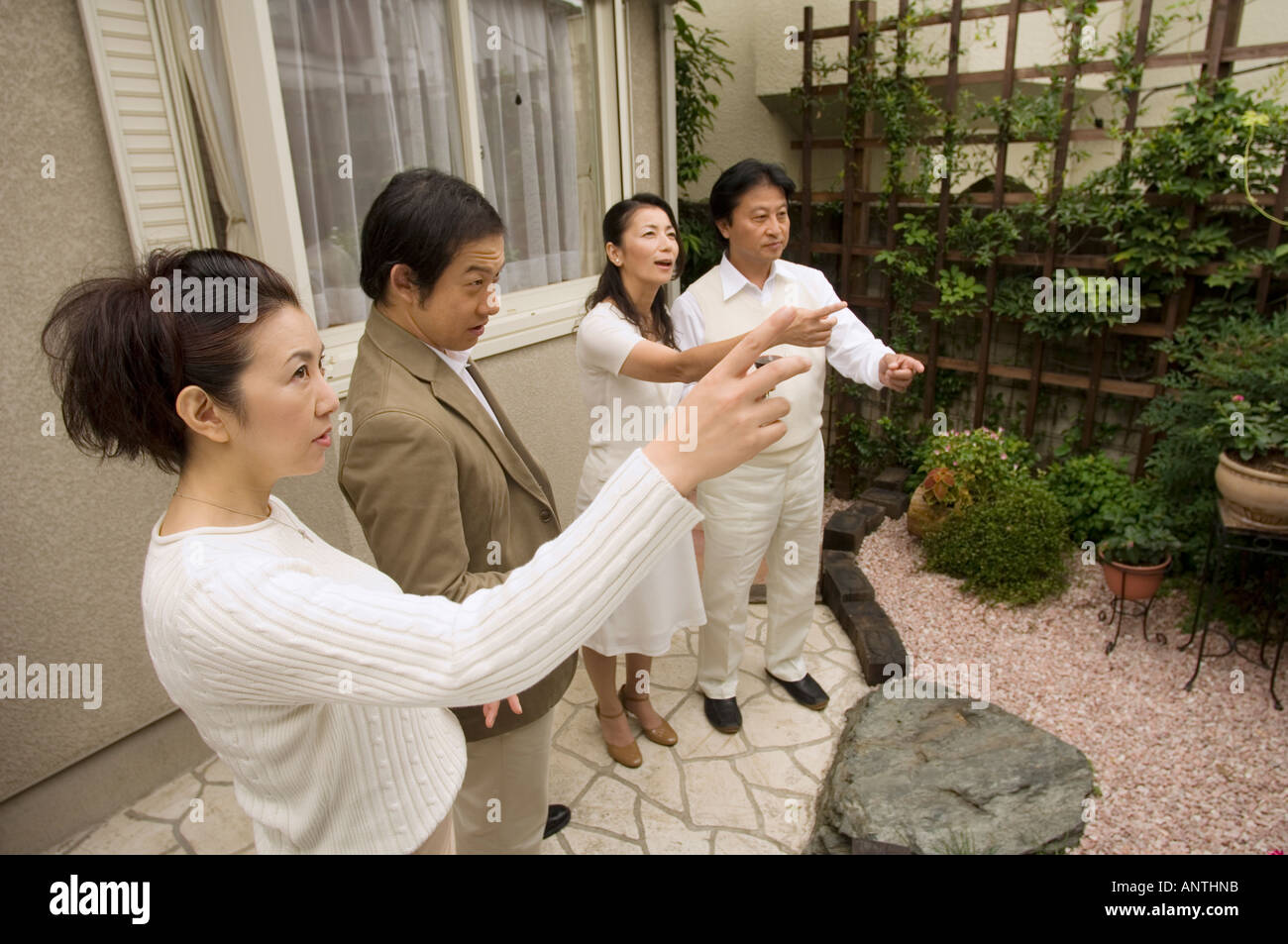 Two mature couples standing outside Stock Photo - Alamy