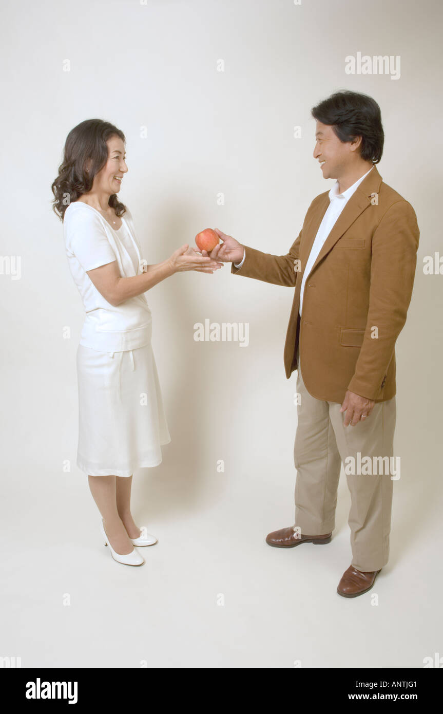 Woman giving apple man hi-res stock photography and images - Alamy