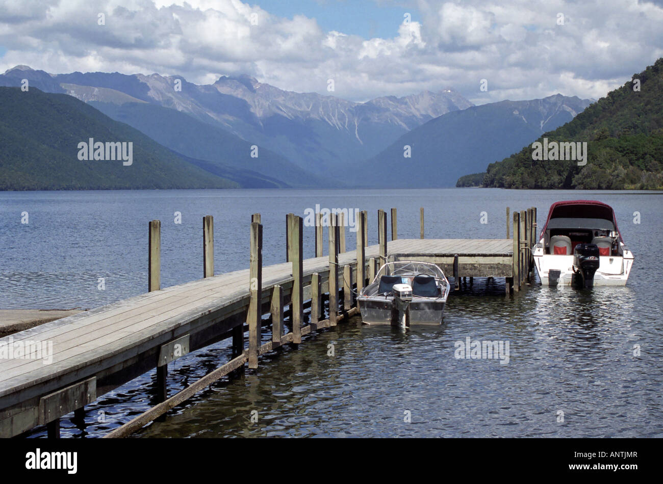 Boat moored alongside a jetty, Lake Rotoroa, Nelson Lakes National Park ...