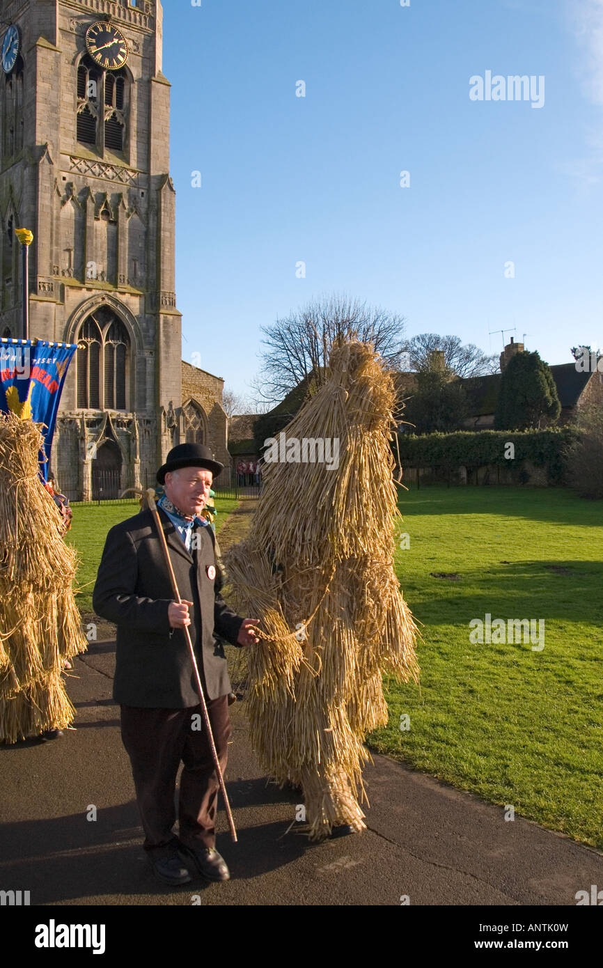 The Whittlesea Straw Bear and keeper pass St. Mary's church in ...