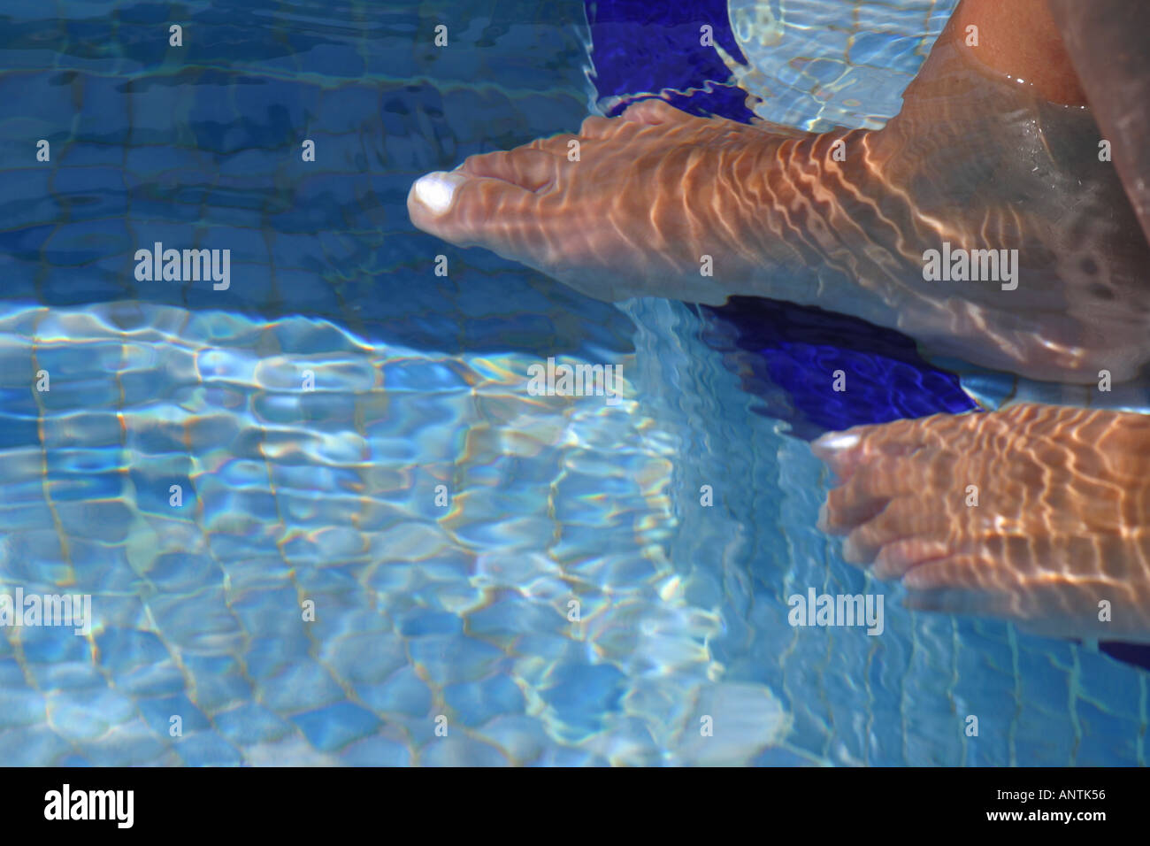 Women resting feet and toes in swimming pool Stock Photo - Alamy