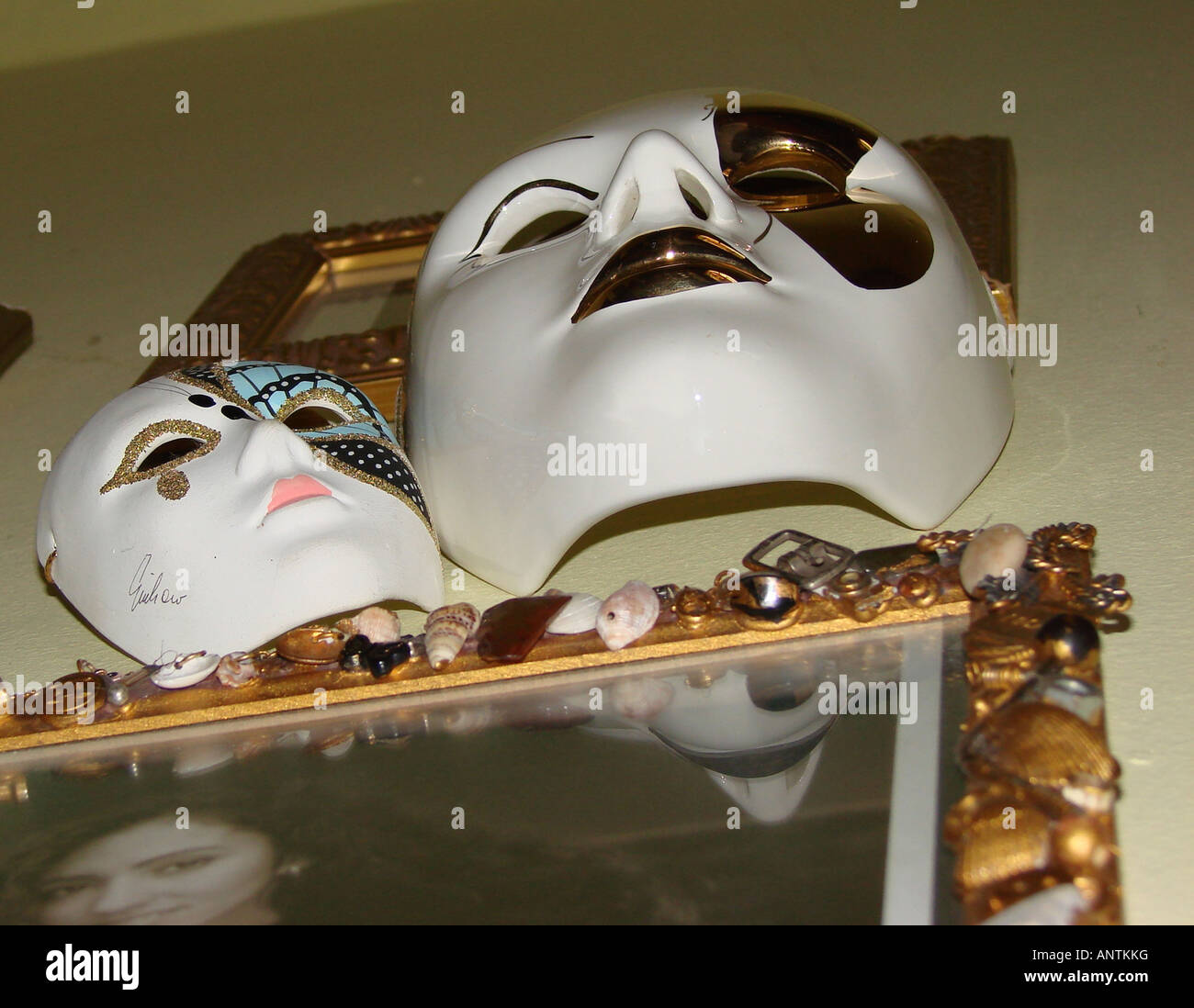 Two masks at the wall Stock Photo - Alamy