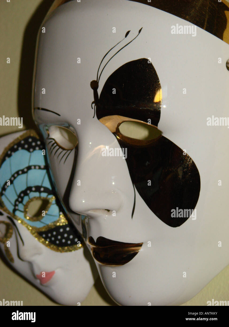Two masks at the wall Stock Photo - Alamy