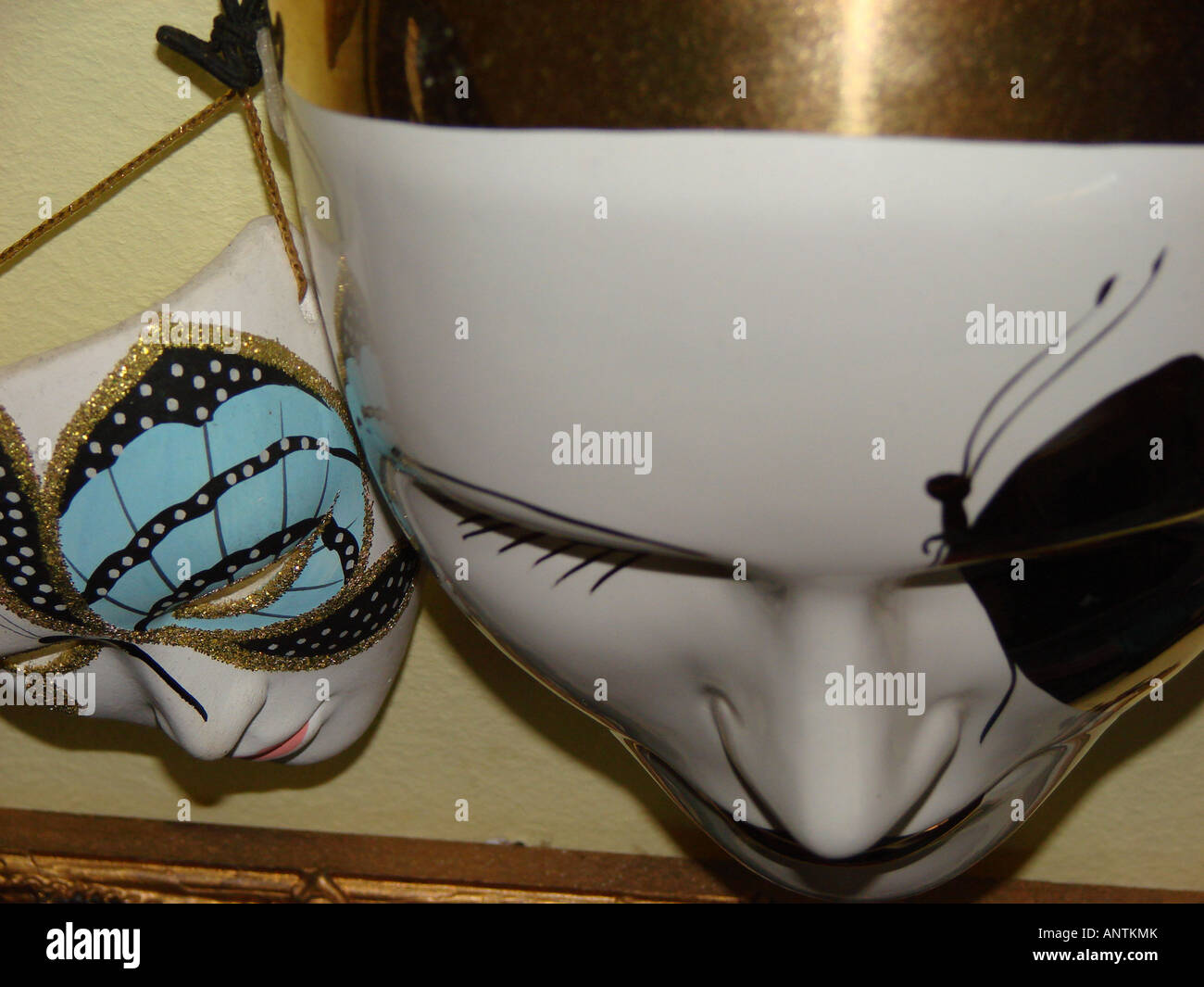 Two masks at the wall Stock Photo - Alamy