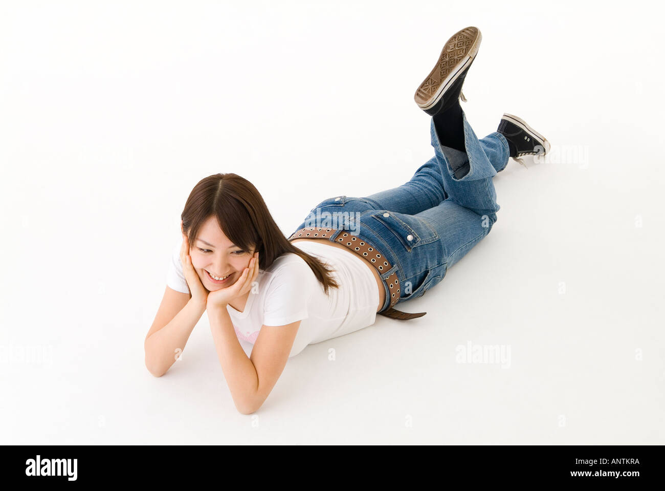 Young woman lying on front smiling Stock Photo - Alamy