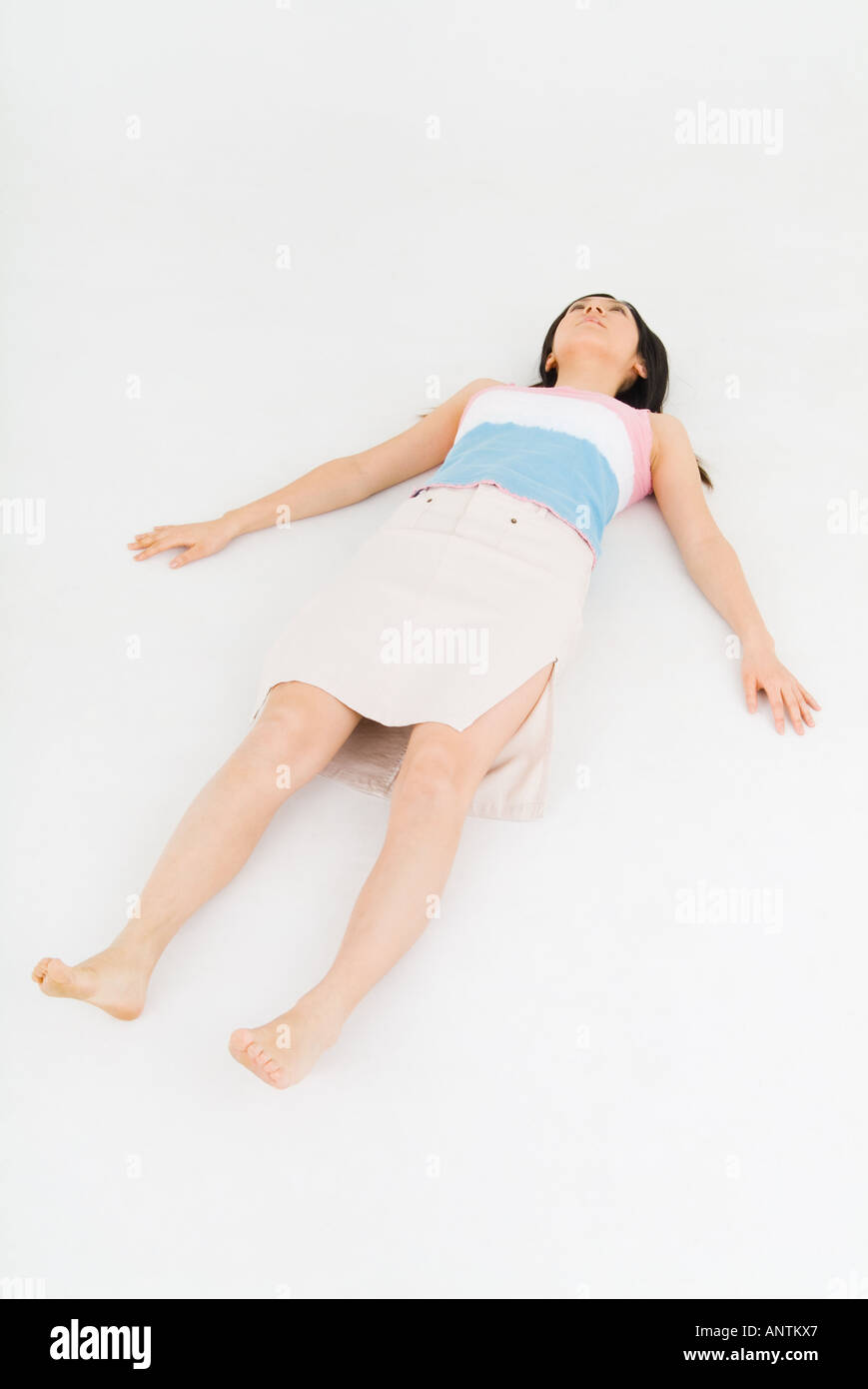 Young woman lying down Stock Photo - Alamy