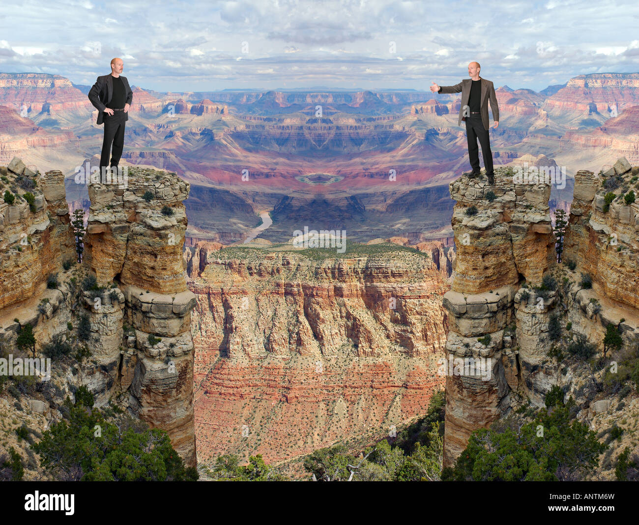 Two men isolated on rock silos with a Grand Canyon chasm separating ...