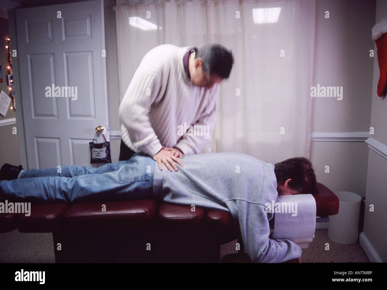 Chiropractor adjusting a patient Stock Photo - Alamy