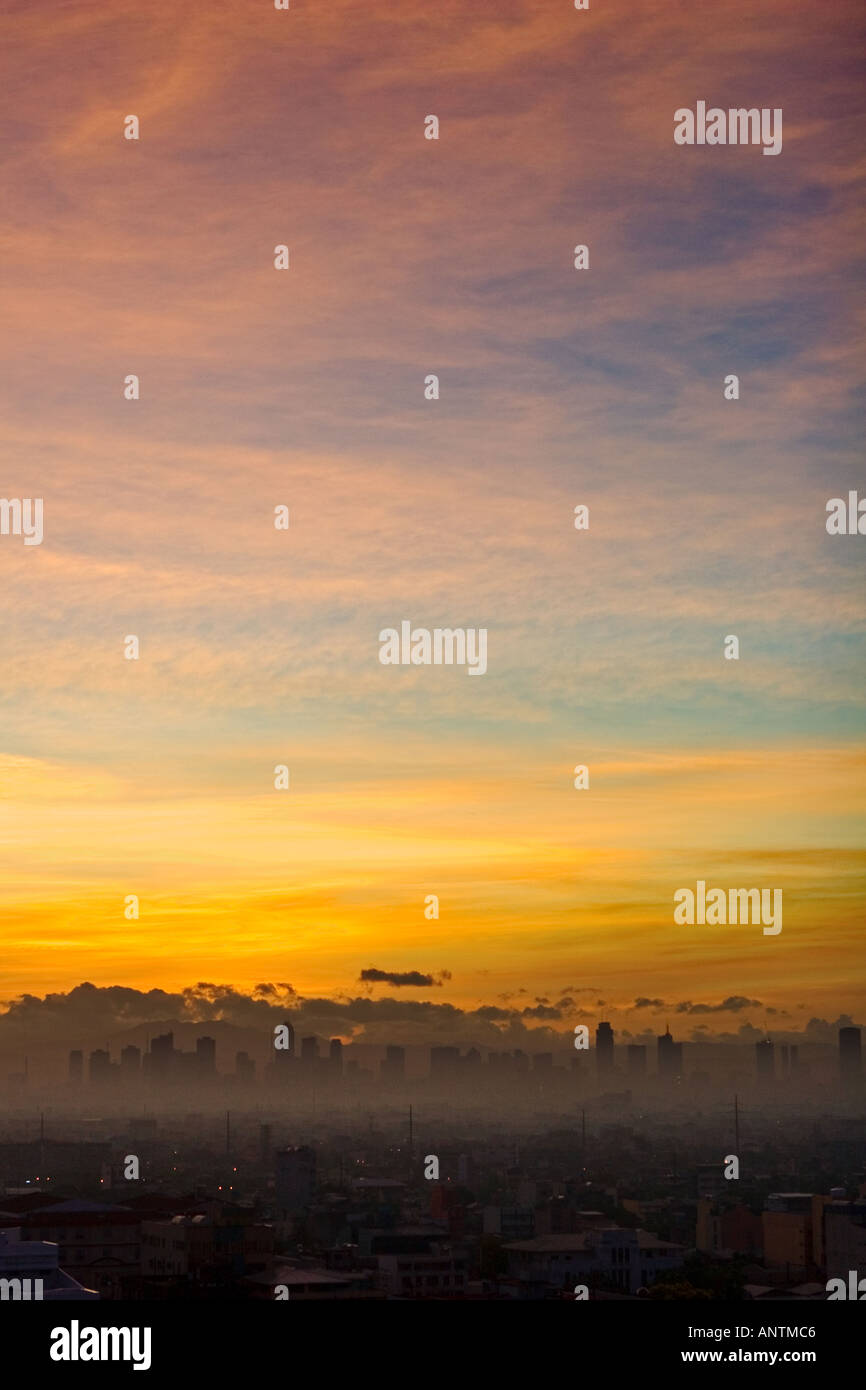 The skyline of Makati City Manila at sunrise shrouded in mist and fog ...