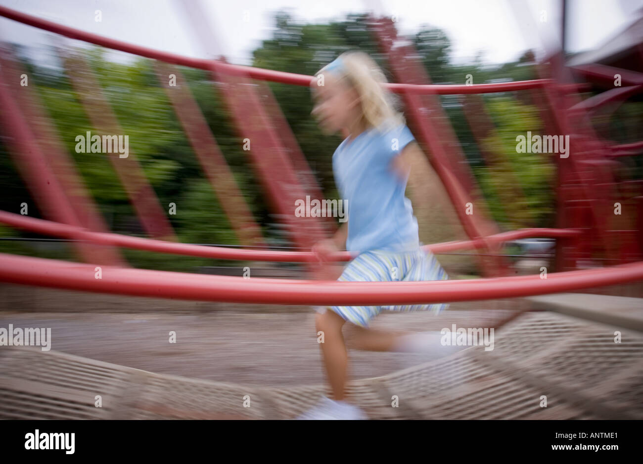 Child running across a playground bridge Stock Photo - Alamy