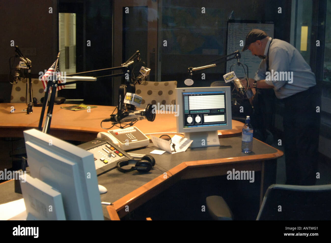 Radio station presenter finishing his spot and making way for the next ...