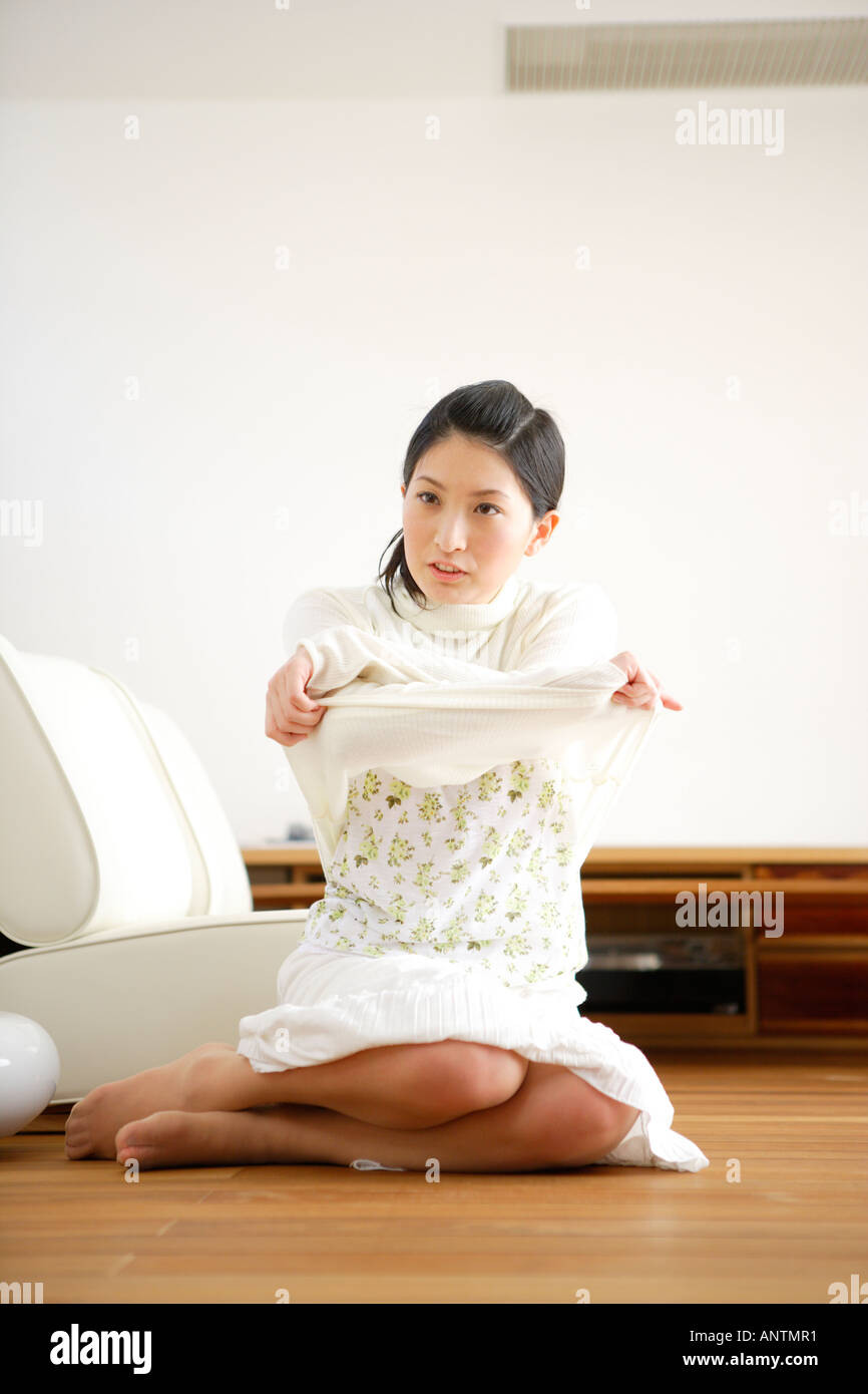 Young woman getting dressed Stock Photo - Alamy