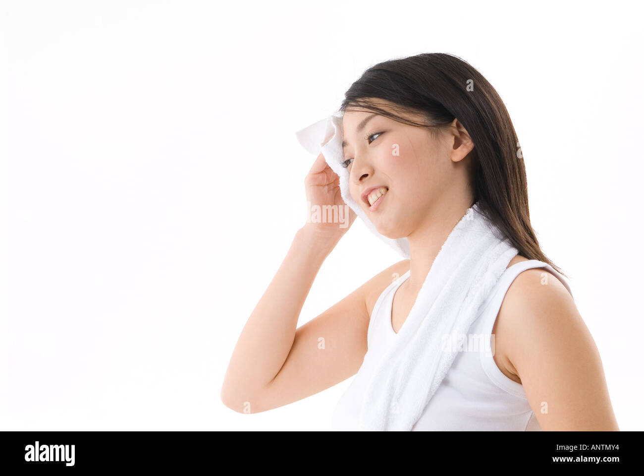 Young woman wiping her face with towel Stock Photo - Alamy
