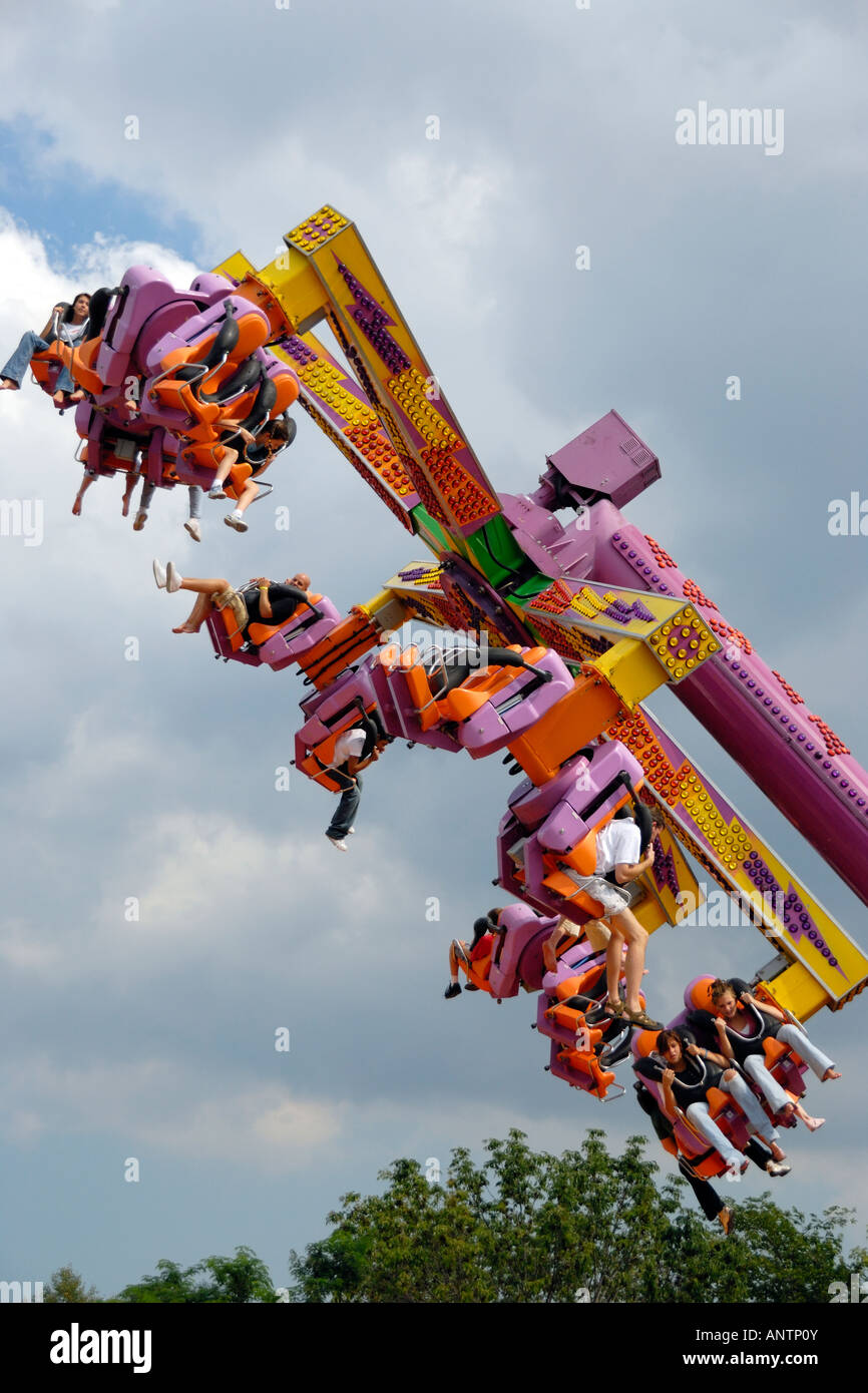 Despite the eminent storm visitors enjoy the amusement park rides ...
