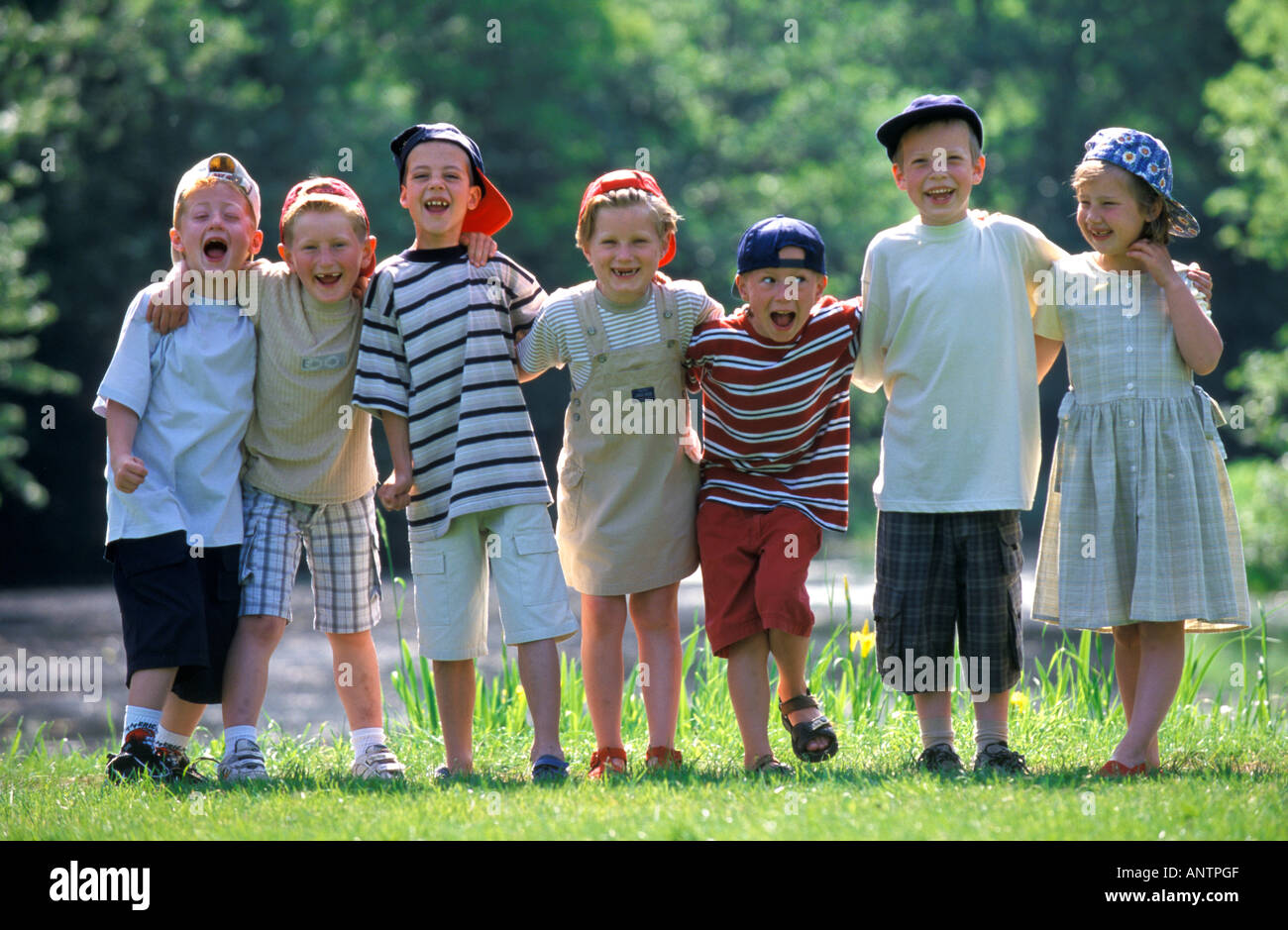Group of seven children in the parc Stock Photo - Alamy
