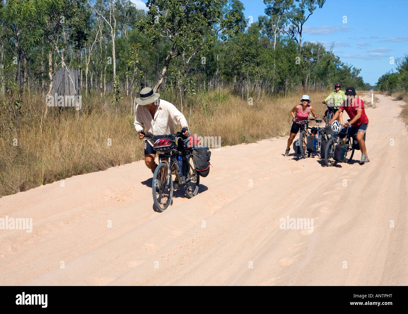 Cyclists slog through sand Stock Photo - Alamy