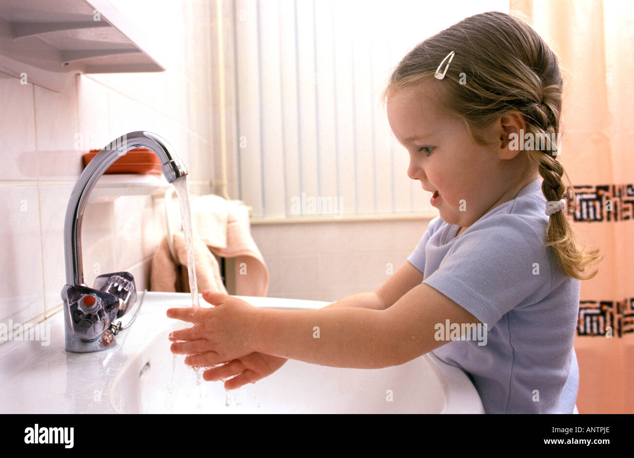 Little girl is washing her hands Stock Photo - Alamy