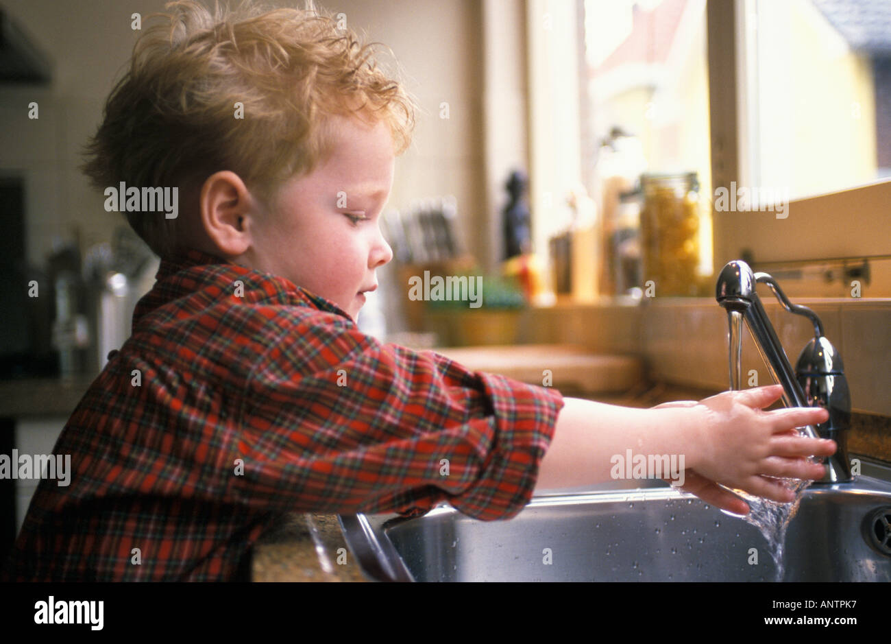Little boy is washing his hands Stock Photo - Alamy
