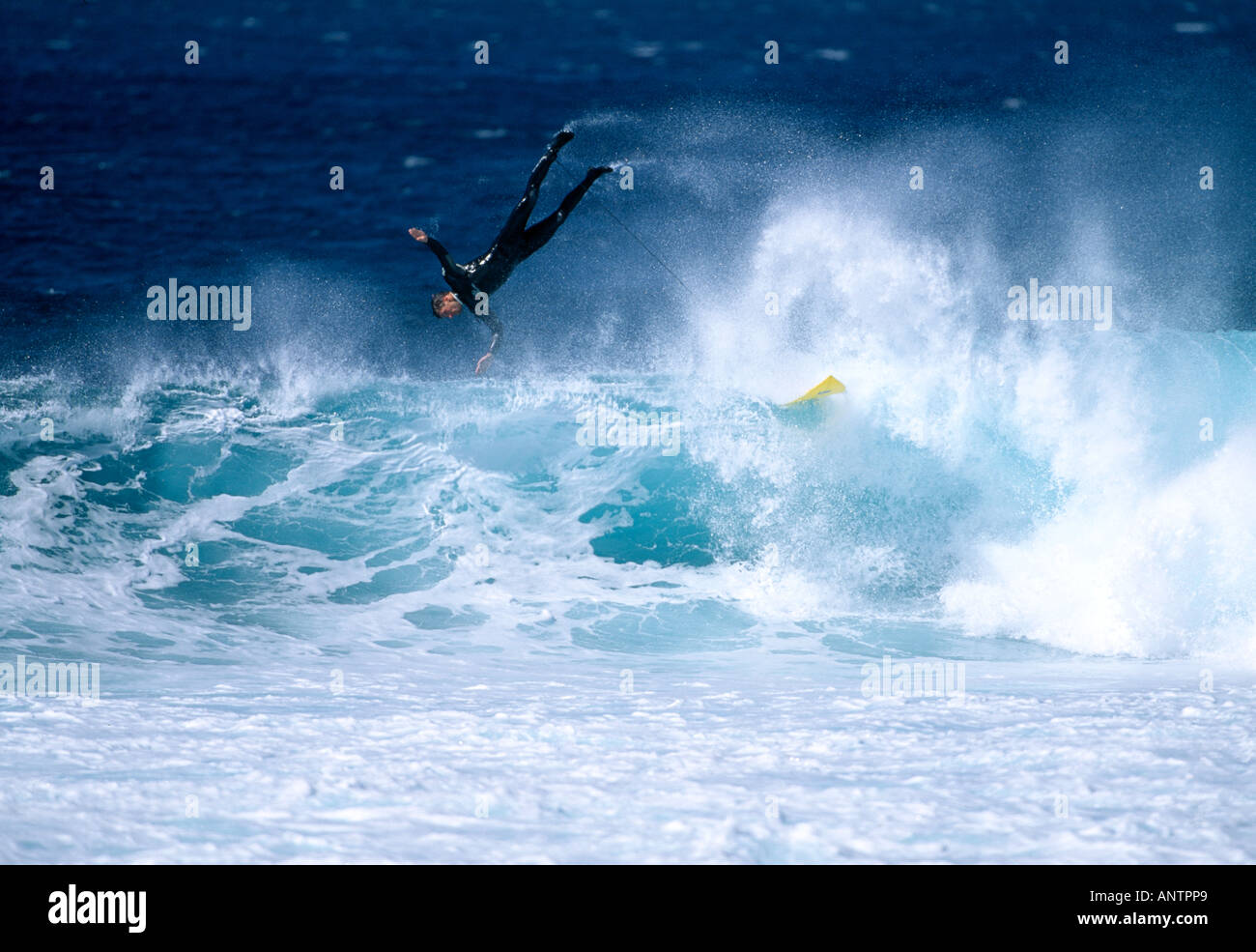 MAN THROWN FROM SURFBOARD MID AIR Stock Photo - Alamy