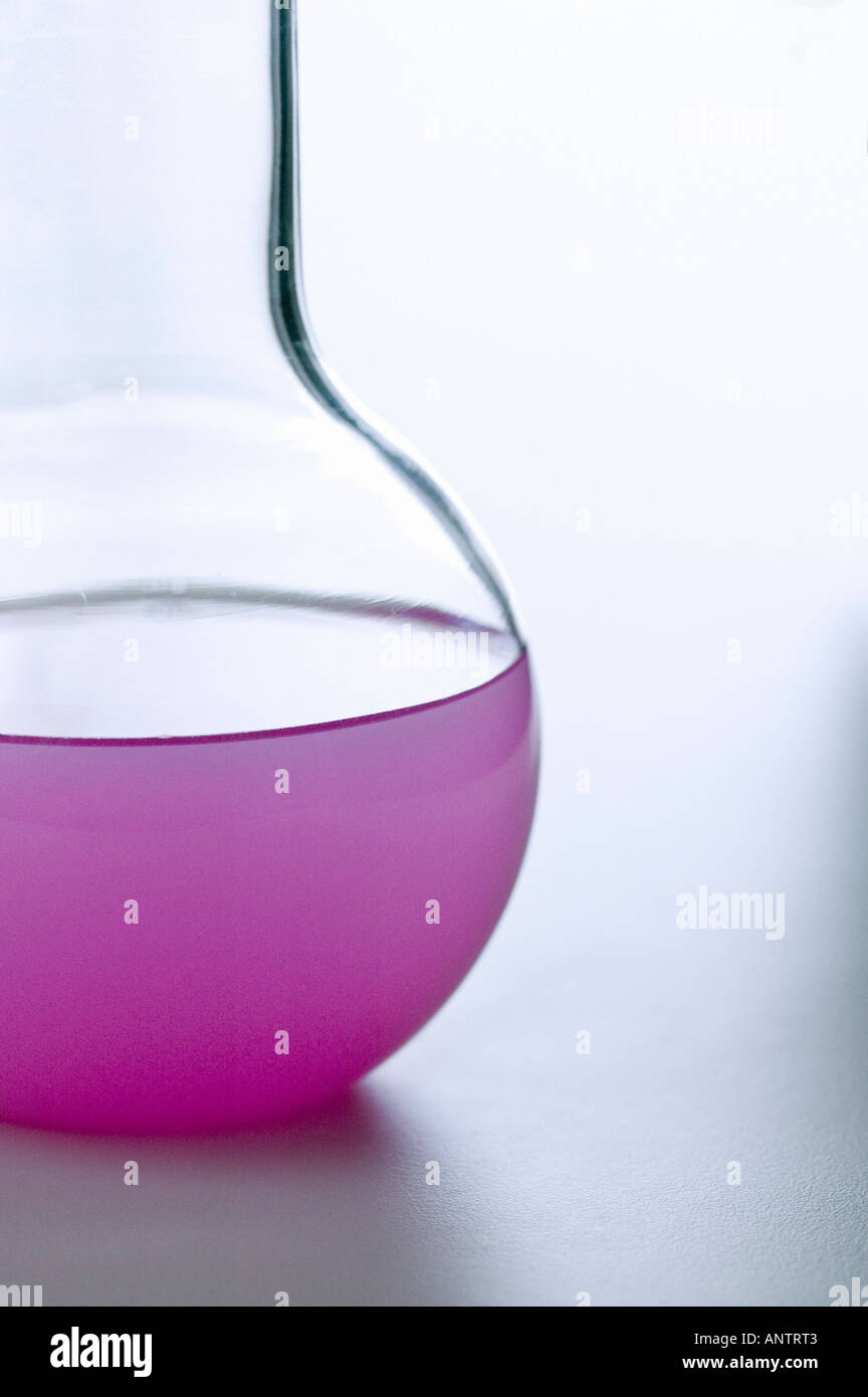 CHEMISTRY MEASURING BEAKER WITH PINK LIQUID INSIDE, CLOSE UP, PART OF ...